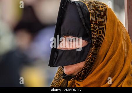 An Omani Bedouin woman wearing a traditional Batoola face covering ...