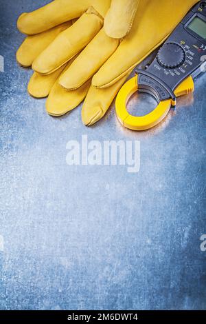 Digital amperemeter safety gloves on metallic background Stock Photo ...