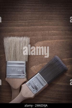 Pair of paint brushes with wood handles construction concept Stock ...