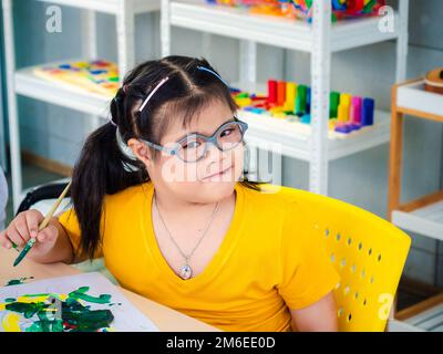 A cheerful group creative arts class for kids and their teacher in the ...