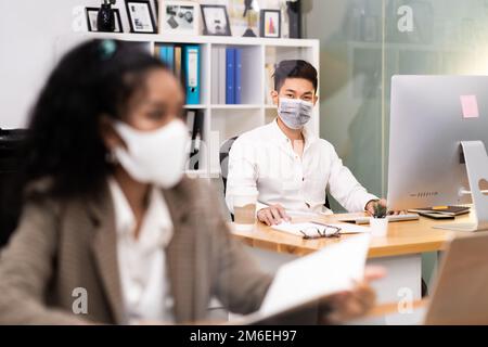 Asian employee face mask in social distance new normal office Stock ...