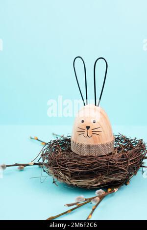 Willow branches, bunny and painted Easter eggs on blue background Stock ...