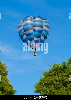 Hamilton New Zealand March 28 2010; bright hot air balloon against blue ...