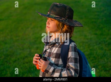 Childhood. Scout boy wearing explorer hat and backpack outdoor ...