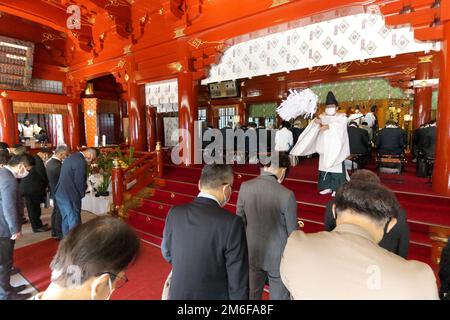 A Shinto priest performs a purification ritual by waiving a harai-gushi ...