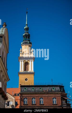 A vertical low-angle shot of the green Northern lights over a modern ...
