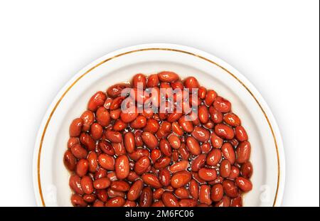 Cooked red kidney beans in a dark ceramic bowl on a rustic wooden table ...