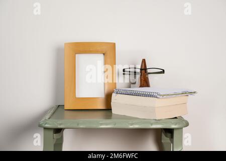 Books with picture frame on wooden table Stock Photo - Alamy