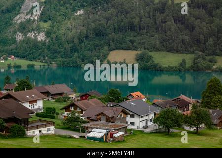 Swiss village Lungern with its traditional houses and old church tower ...