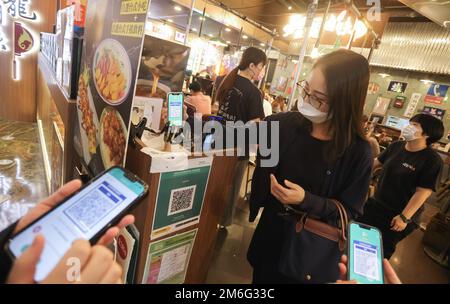 Diners scanning their LeaveHomeSafe QR code during lunchtime, at ...