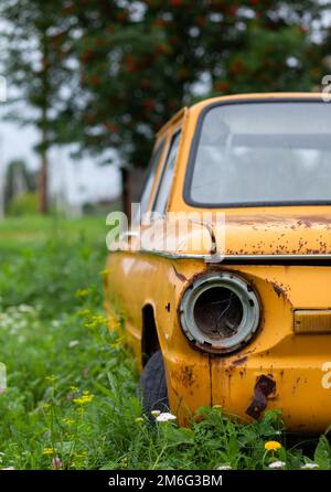 Old yellow wrecked car in vintage style. Abandoned rusty yellow car ...
