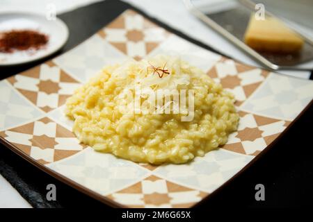 Risotto with safron and parmesan cheese. Risotto is a northern Italian ...