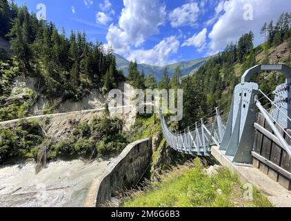 Suspension bridge over dam in the Austrian mountains Stock Photo - Alamy