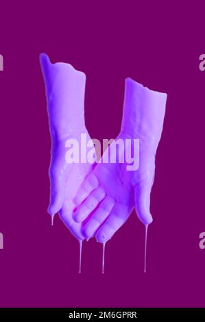 Human fingers dipped in color paint. Painted hands. Liquid drips off ...
