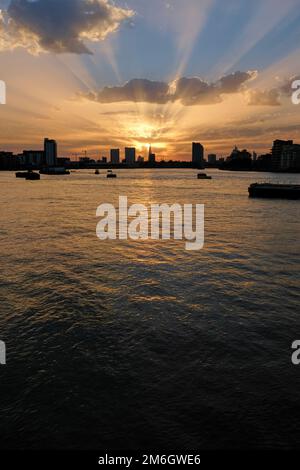 Golden rays of sun shine out from behind the Shard in the distance over ...