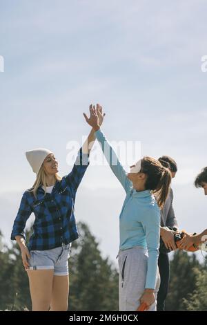 Two beautiful girls high fiving while having fun with the market cart ...