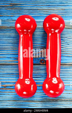 Red dumbbells on vintage wooden board Stock Photo - Alamy