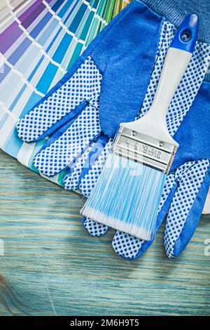 Safety gloves paint brushes color sampler on wooden board Stock Photo ...