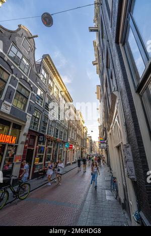 Very narrow alley in the streets of Amsterdam with graffiti and ...