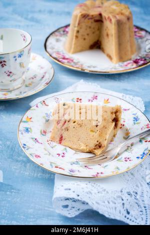 Traditional Australian plum pudding as closeup with fruits and vanilla ...