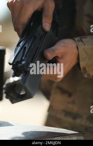 A U.S. Army soldier holds the buffer assembly of the M2A1 .50 Caliber ...