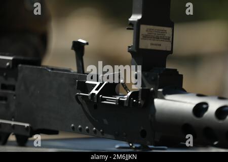 A headspace and timing gauge rests in an M2 .50 caliber machine gun ...