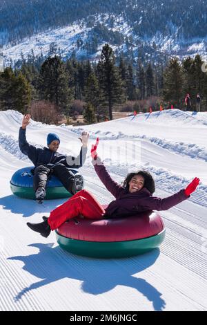 A family snow tubing in Stateline, Nevada Stock Photo - Alamy