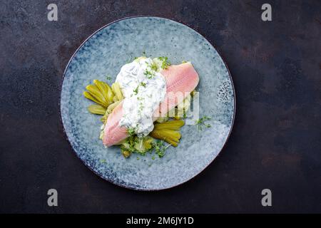 Modern style traditional smoked rainbow trout with boiled potato salad ...