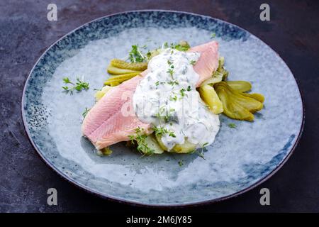 Modern style traditional smoked rainbow trout with boiled potato salad ...
