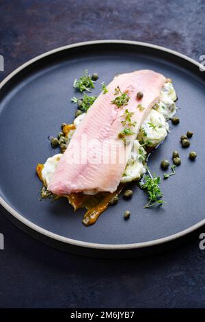 Modern style traditional smoked rainbow trout with boiled potato salad ...