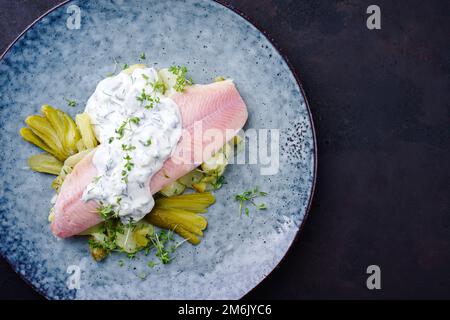 Modern style traditional smoked rainbow trout with boiled potato salad ...