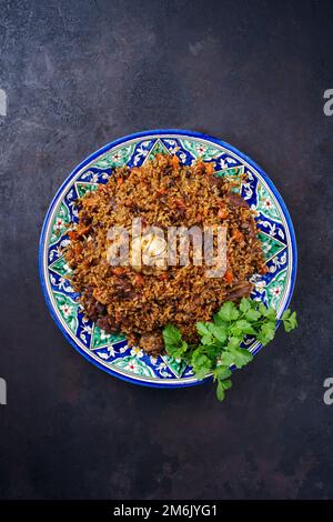 Traditional Uzbek fergana plov with devsira rice and lamb meat served ...