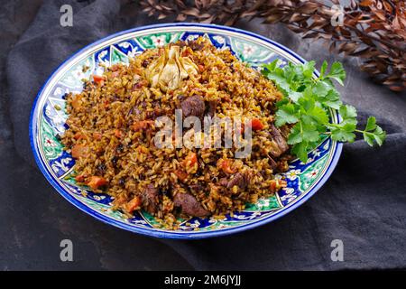 Traditional Uzbek fergana plov with devsira rice and lamb meat served ...