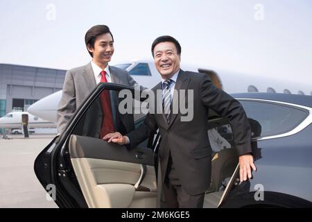 Business man arrive at the airport limousine Stock Photo - Alamy