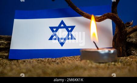 Israeli flag and burning candles in front of it, Holocaust memory day ...