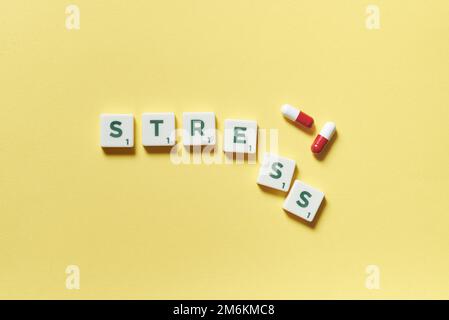 Stress formed of scrabble tiles and pharmaceutical pills Stock Photo ...