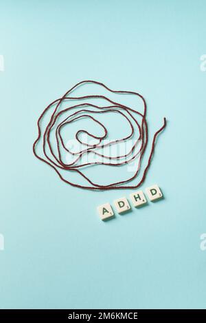 ADHD formed of scrabble tiles with tangled thread Stock Photo - Alamy