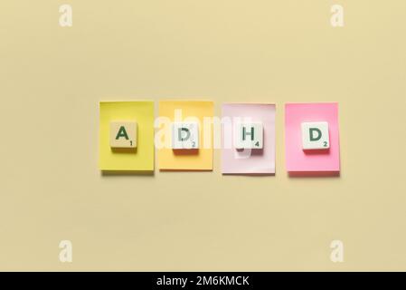 ADHD formed of scrabble tiles on sticky notes Stock Photo - Alamy