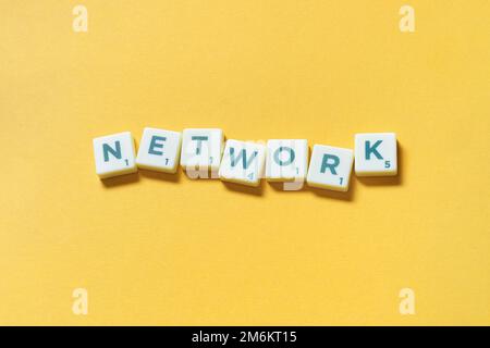 Network formed of scrabble elements on yellow background Stock Photo ...