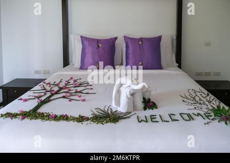 Cozy bedroom interior with grey pillows, white linens, wooden headboard ...