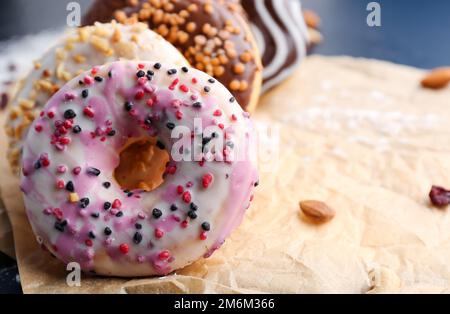 Sheet of baking paper with tasty donuts, closeup Stock Photo - Alamy