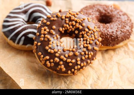 Sheet of baking paper with tasty donuts, closeup Stock Photo - Alamy