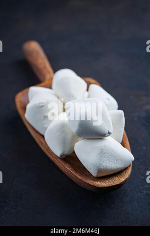 Traditional Afghan dried curd kashk pieces as close-up on black rustic ...