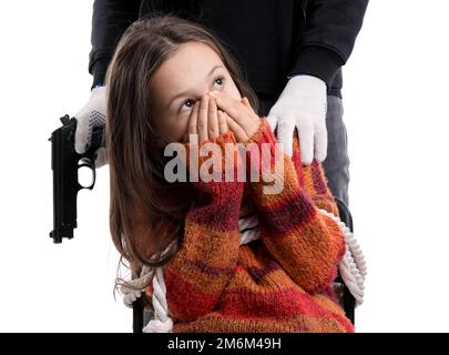 Terrorist with gun and scared little hostage on white background Stock ...
