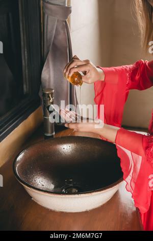 Cosmetic liquid pouring from bottle isolated on white Stock Photo - Alamy