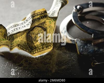 Handcuffs, dollar bills and drug powder Stock Photo - Alamy