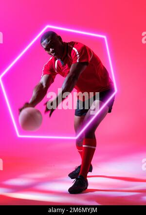 African american male player throwing rugby ball by illuminated ...