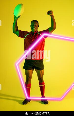 African american rugby player with arms raised throwing ball over ...