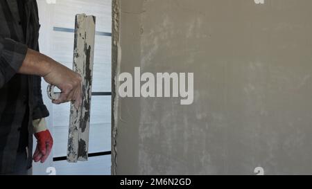 Wall putty repair after installing the socket box Stock Photo - Alamy