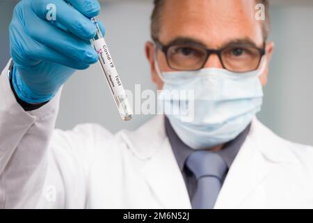 man with face mask is handling a probe tube Stock Photo - Alamy